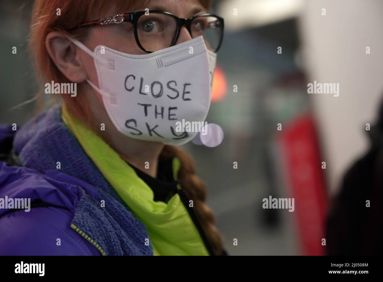 WARSAW, POLAND - MARCH 15, 2022 - A woman wears a face mask that reads ...