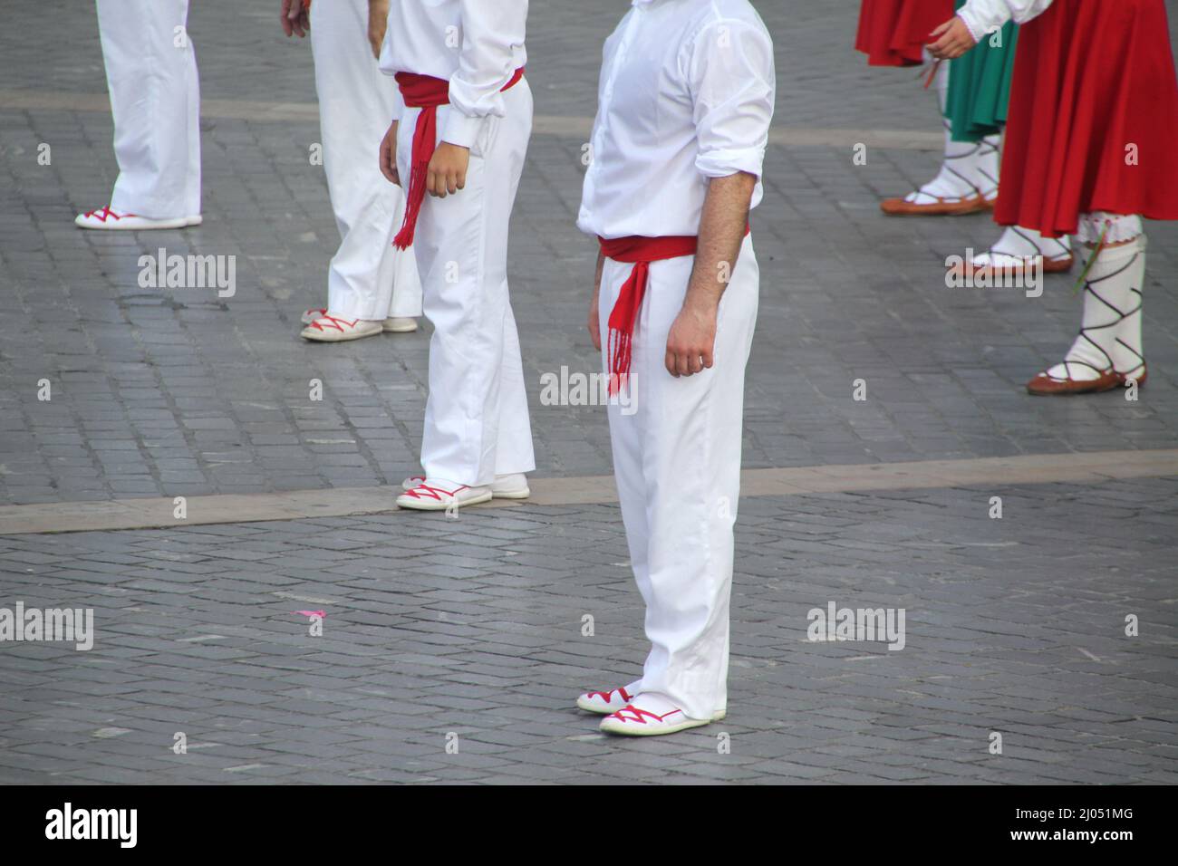 Group of people dancing a Basque folk dance in the street with ...
