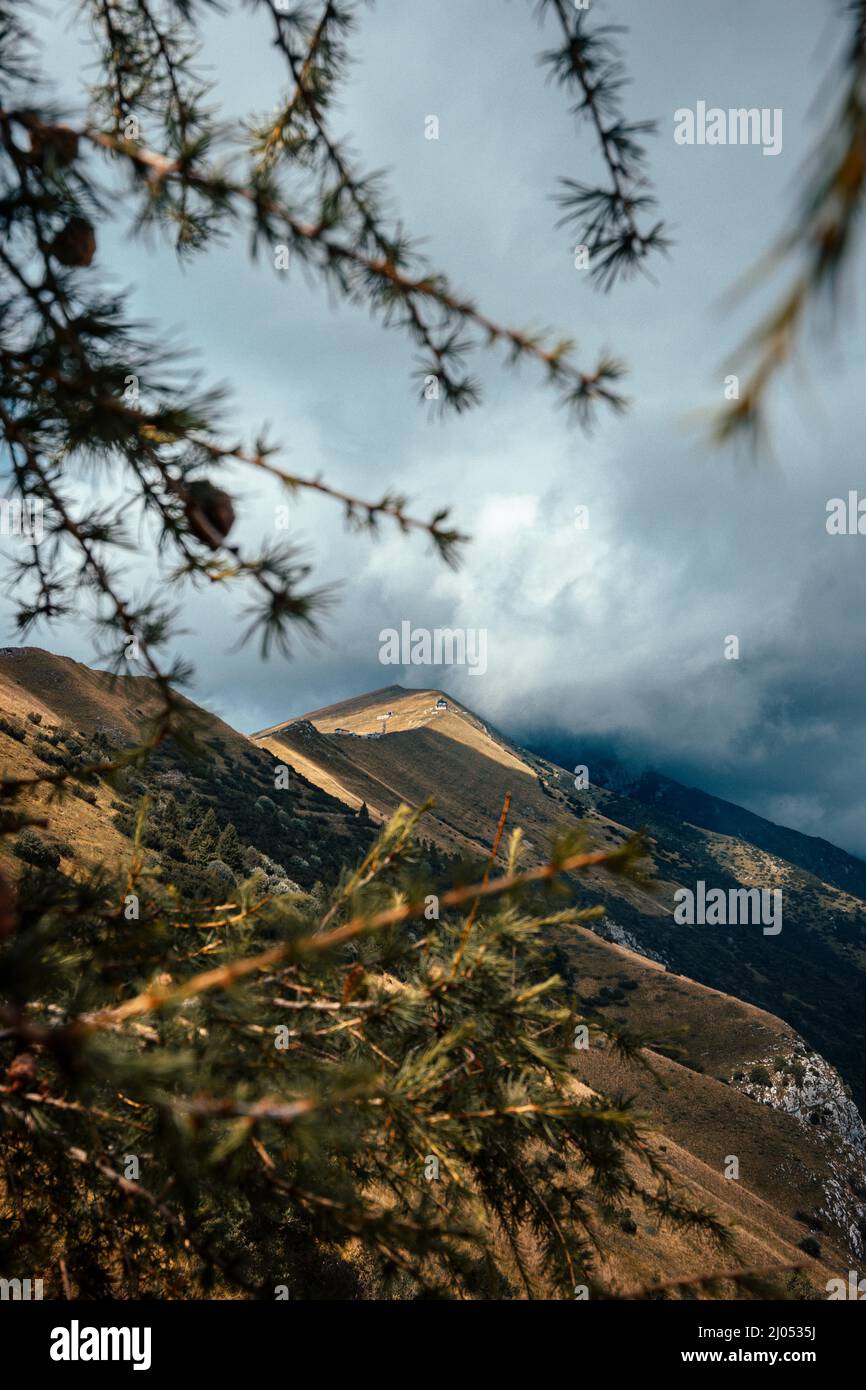 Scenic vertical shot of the mountains range of Monte Baldo covered with ...
