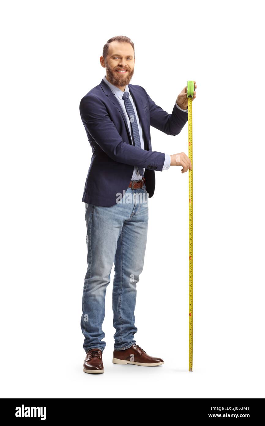 Young man using a steel measuring tape and smiling isolated on white ...