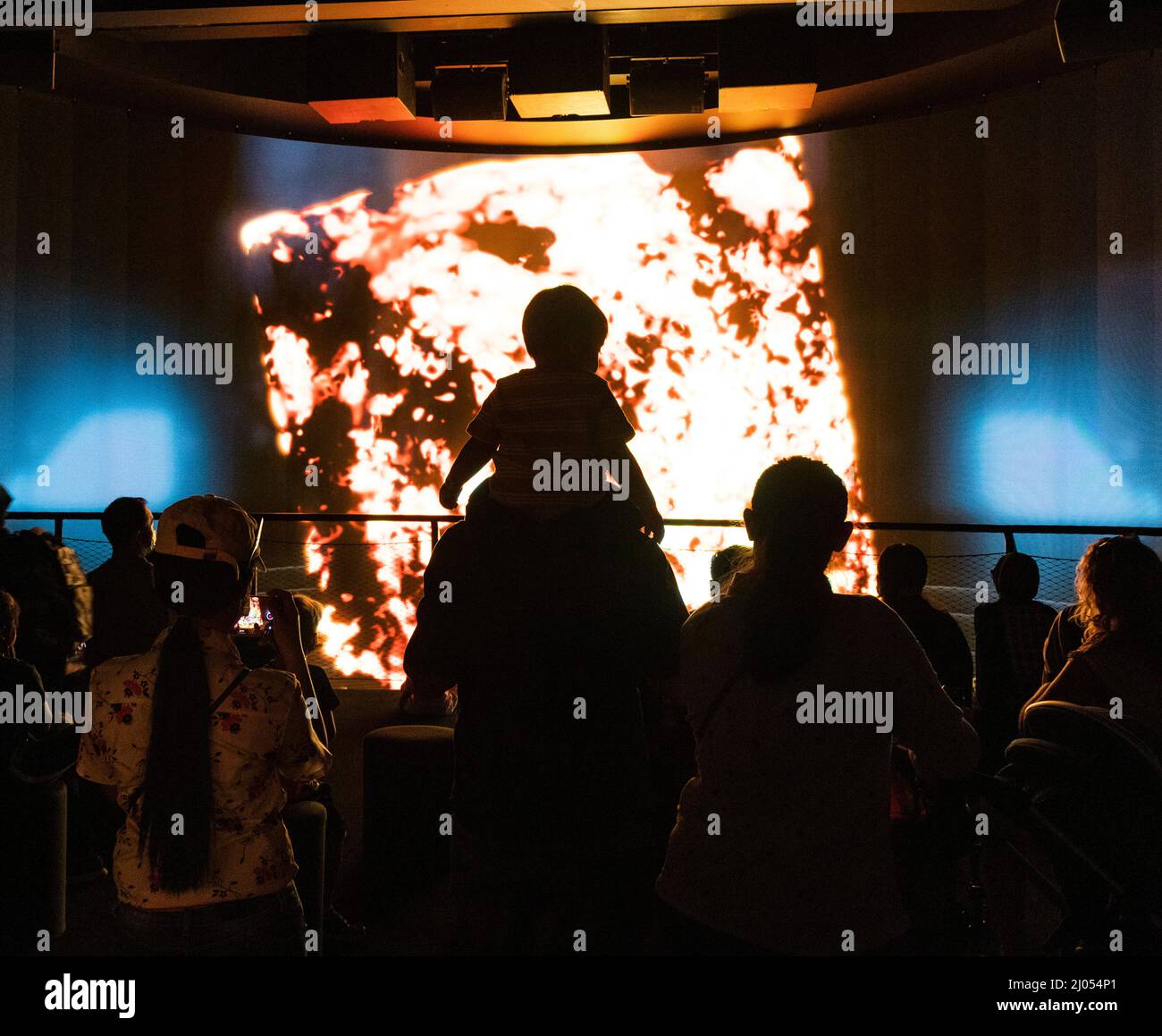 People watching video reel projected on the wall Stock Photo - Alamy