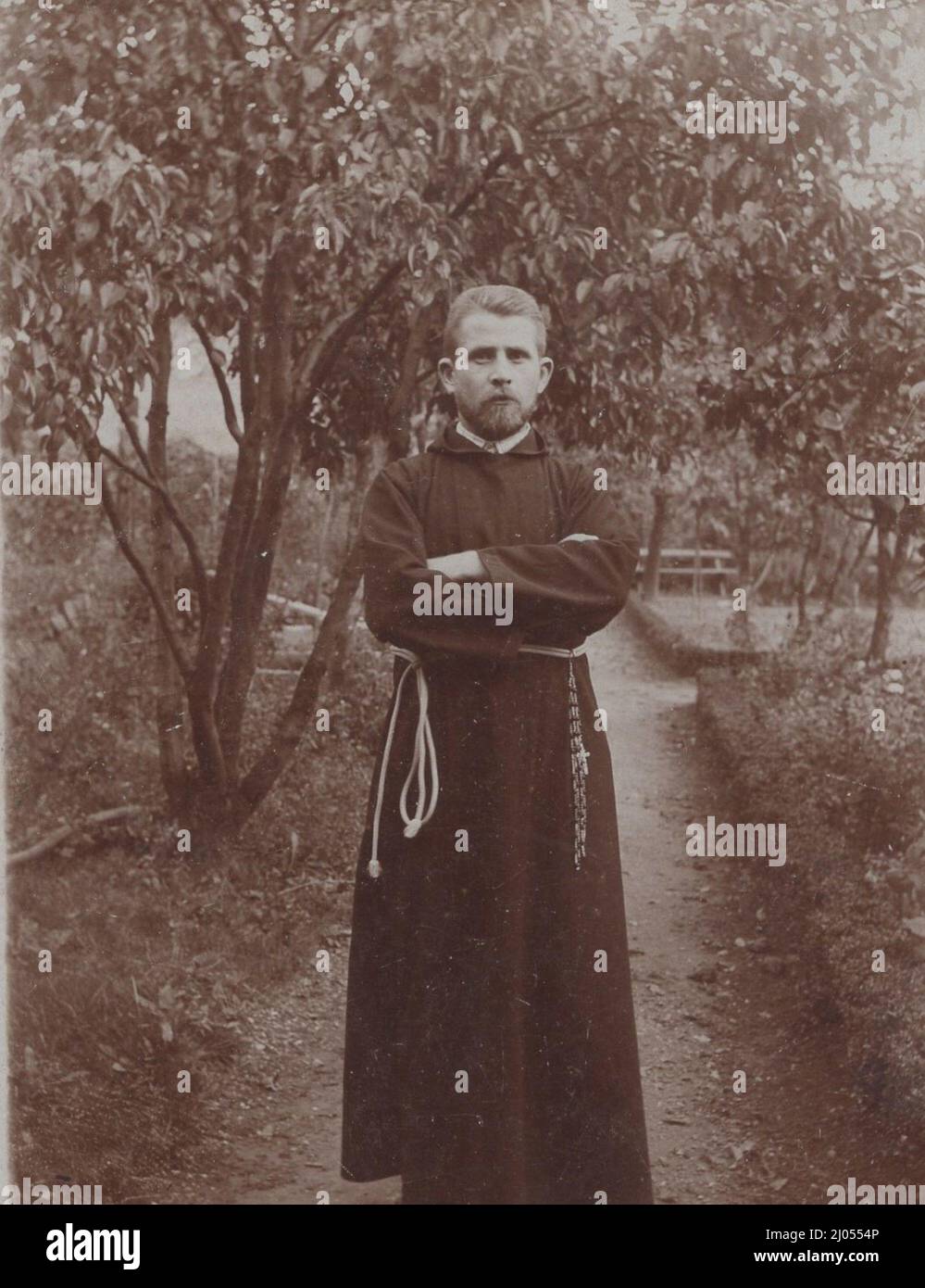 A young handsome roman catholic Franciscan Monk is posing very well for ...