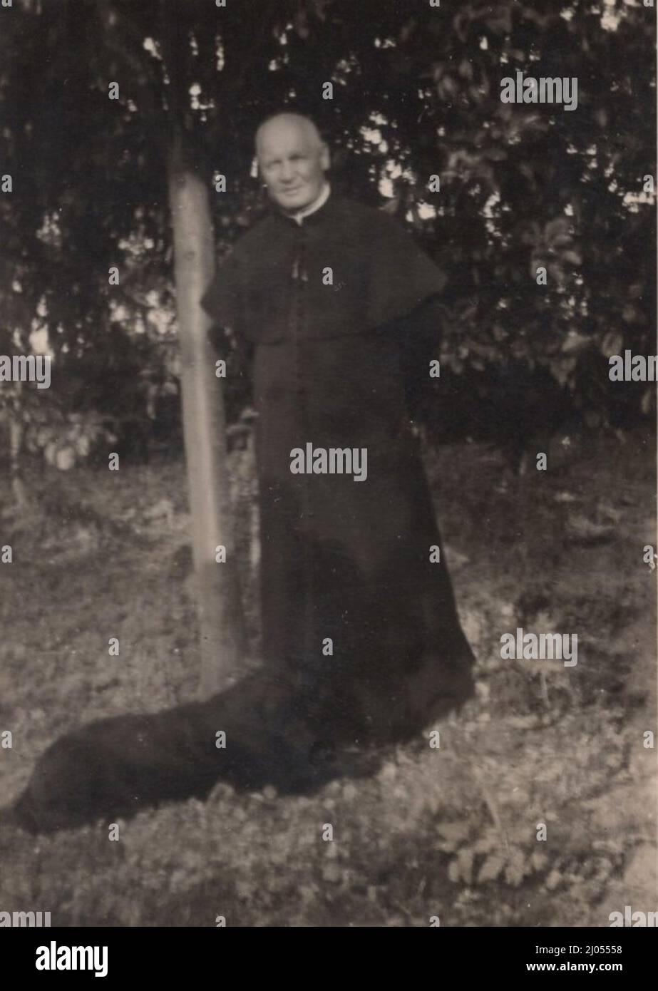 A proud high ranking roman catholic priest is posing for the camera at ...