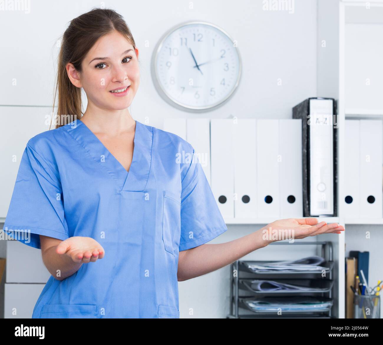 Female doctor making welcome gesture hi-res stock photography and ...