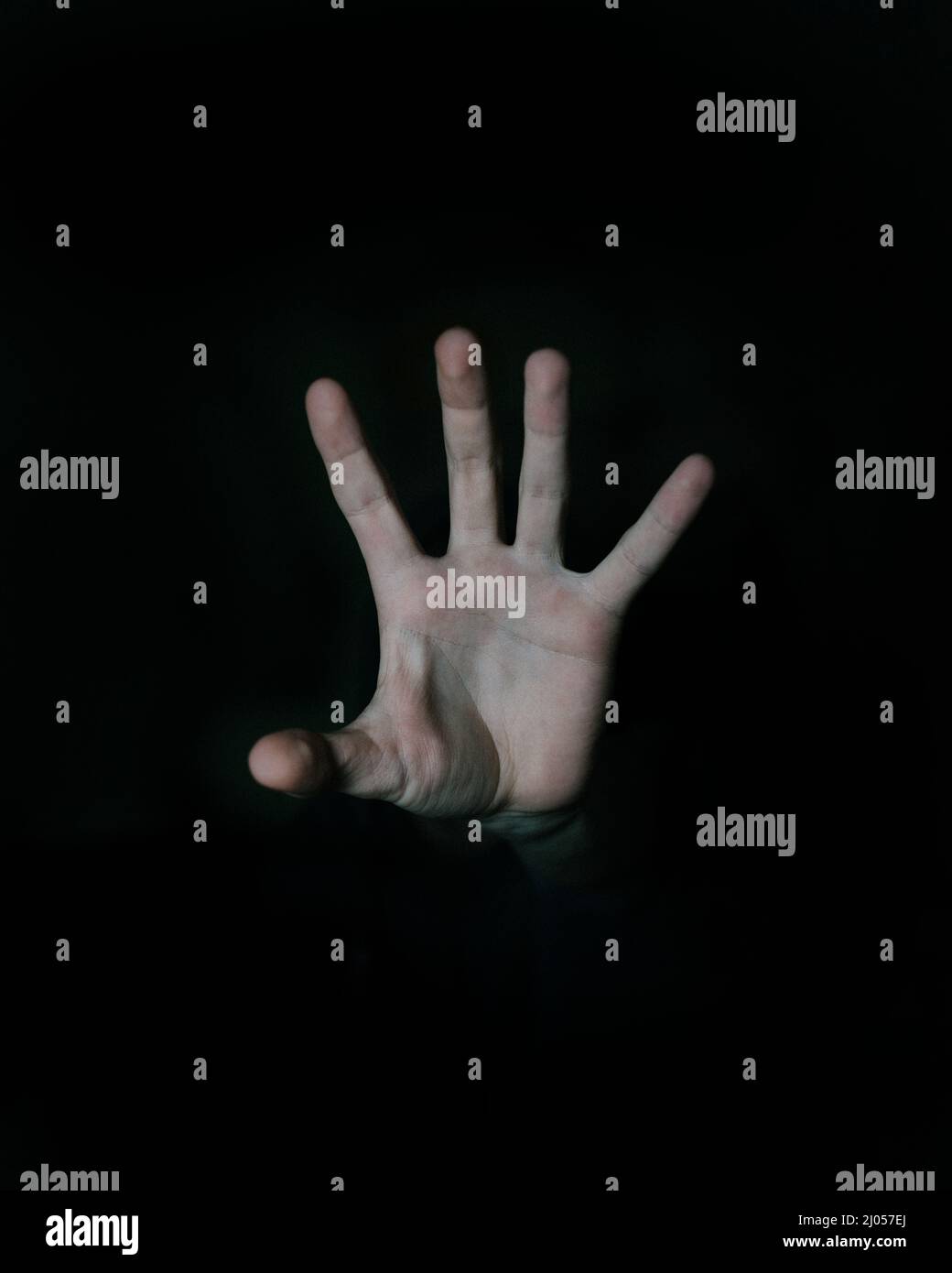 Selective of an open hand in the darkness Stock Photo - Alamy