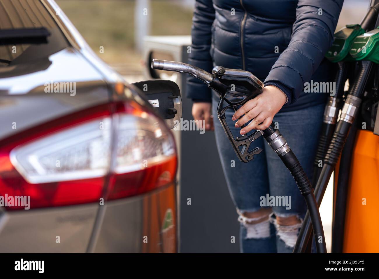 Process of refueling a car fill with petrol fuel at the gas station ...