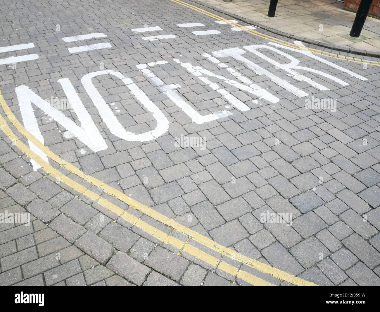 No Entry words signage painted on a city street across a give way ...