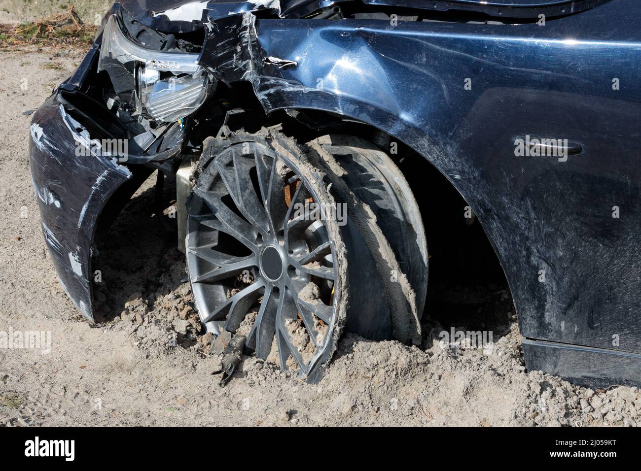 A close-up shot of a broken car stuck in the dry ground Stock Photo - Alamy