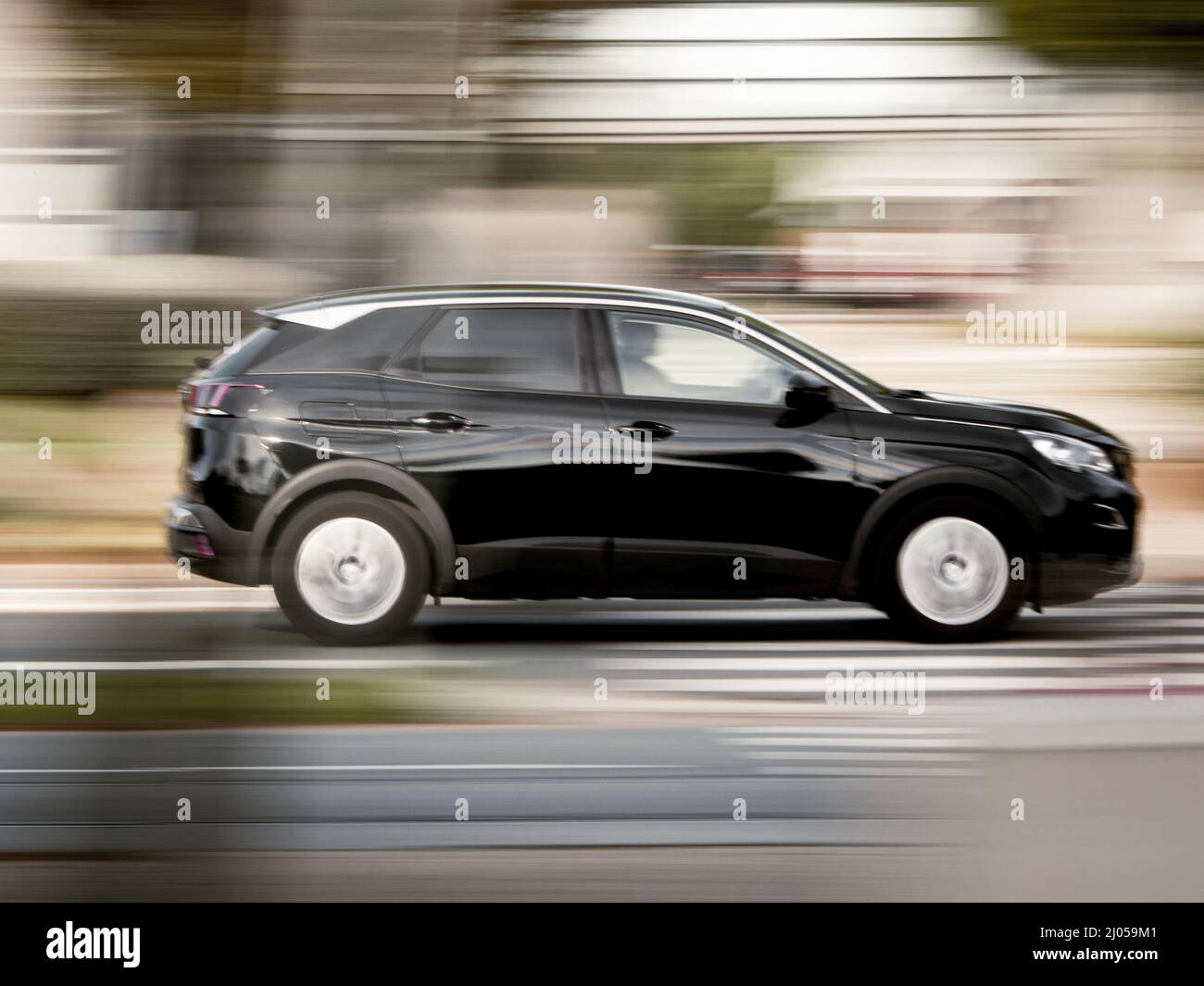 Black Peugeot 3008 driving fast on the road Stock Photo - Alamy