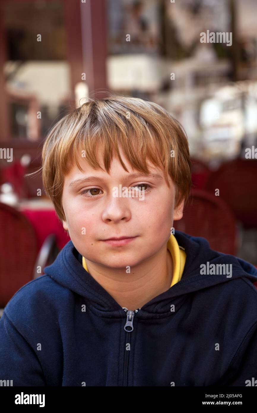 portrait of a handsome smiling boy sitting outside Stock Photo - Alamy