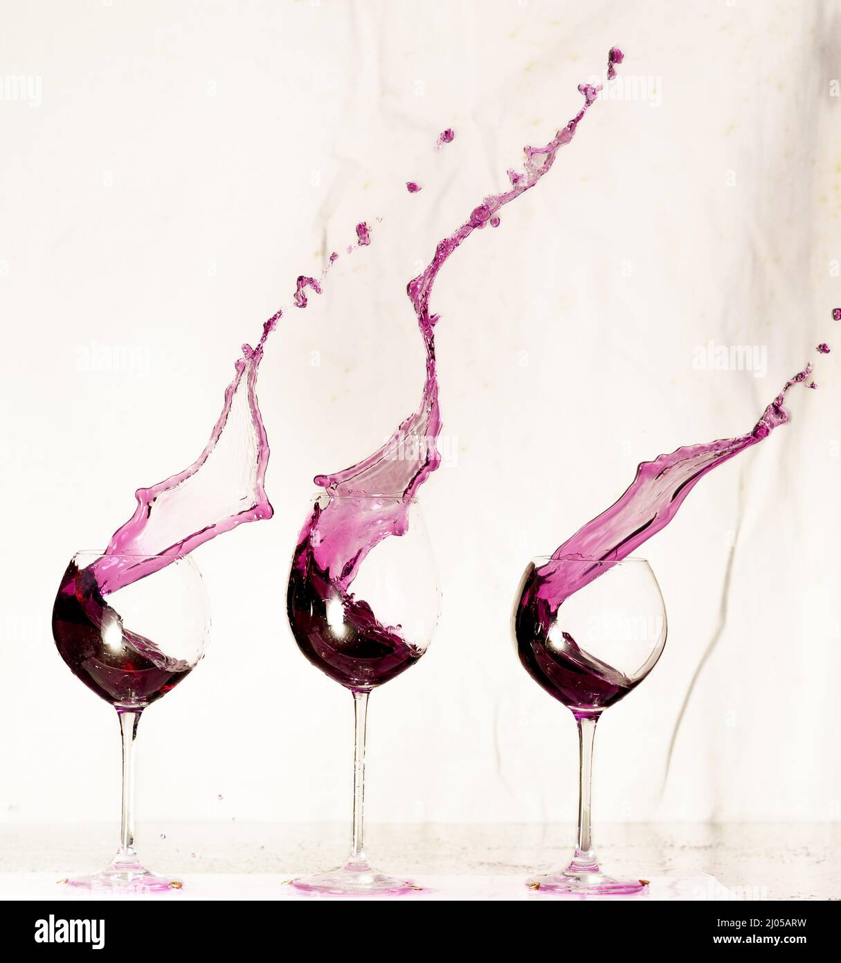 Red wine splash on light background with texture Stock Photo - Alamy