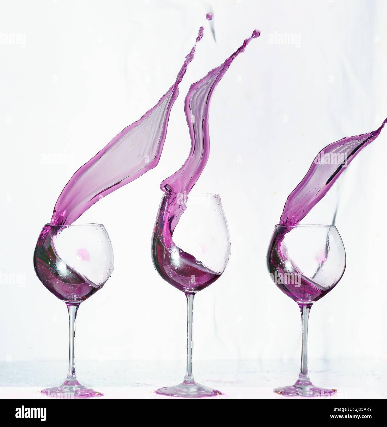 Red wine splash on light background with texture Stock Photo - Alamy