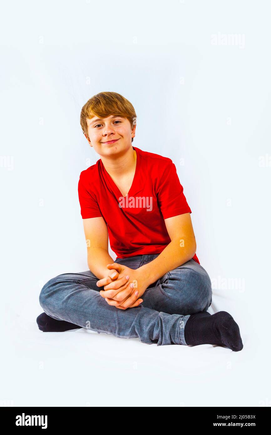 cute handsome boy sitting at the floor Stock Photo - Alamy