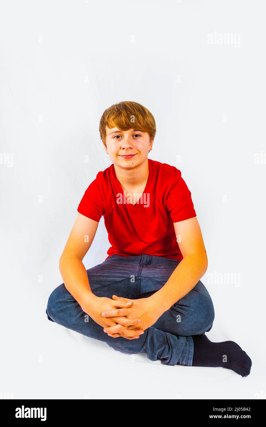 cute handsome boy sitting at the floor Stock Photo - Alamy