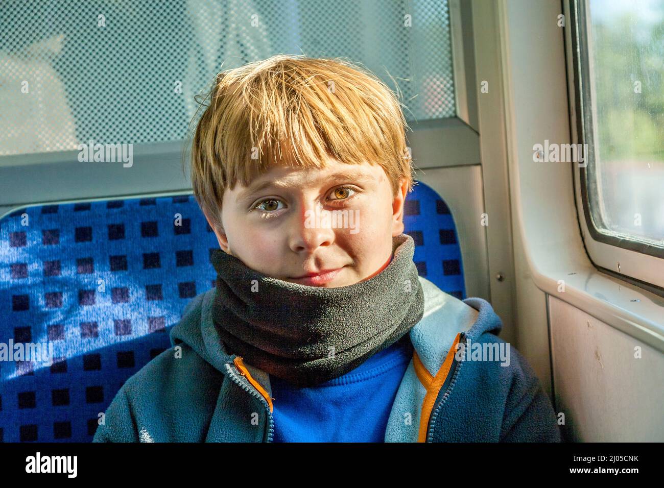 cute boy sitting in the train in sunlight Stock Photo - Alamy