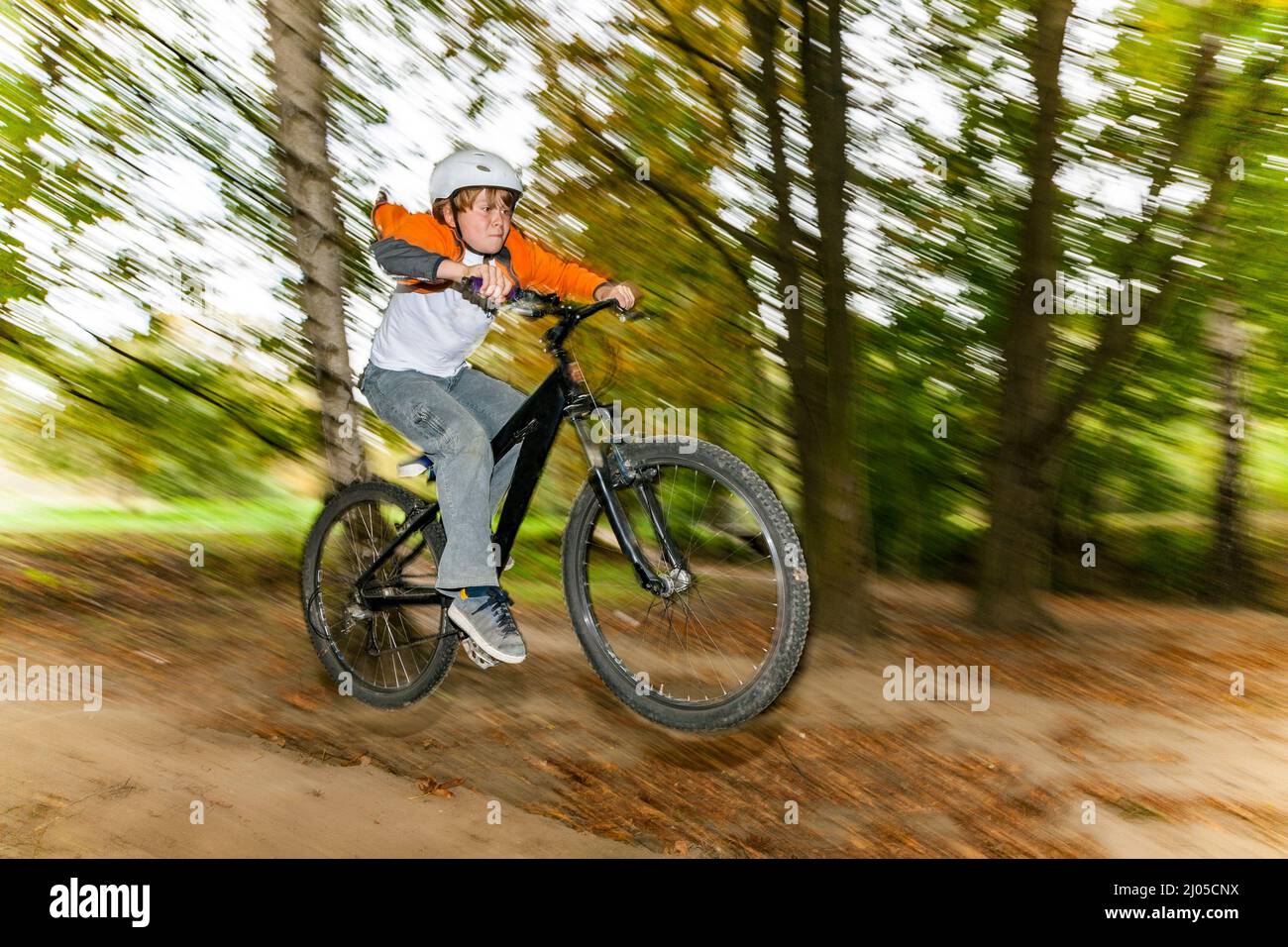 boy jumping over a ramp with his dirtbike Stock Photo - Alamy
