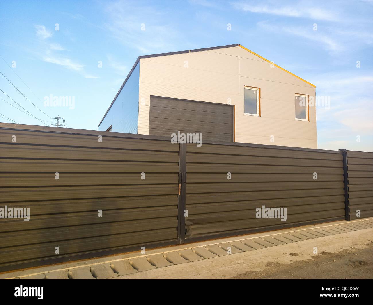 Warehouse building with fence. Industrial warehouse Stock Photo - Alamy