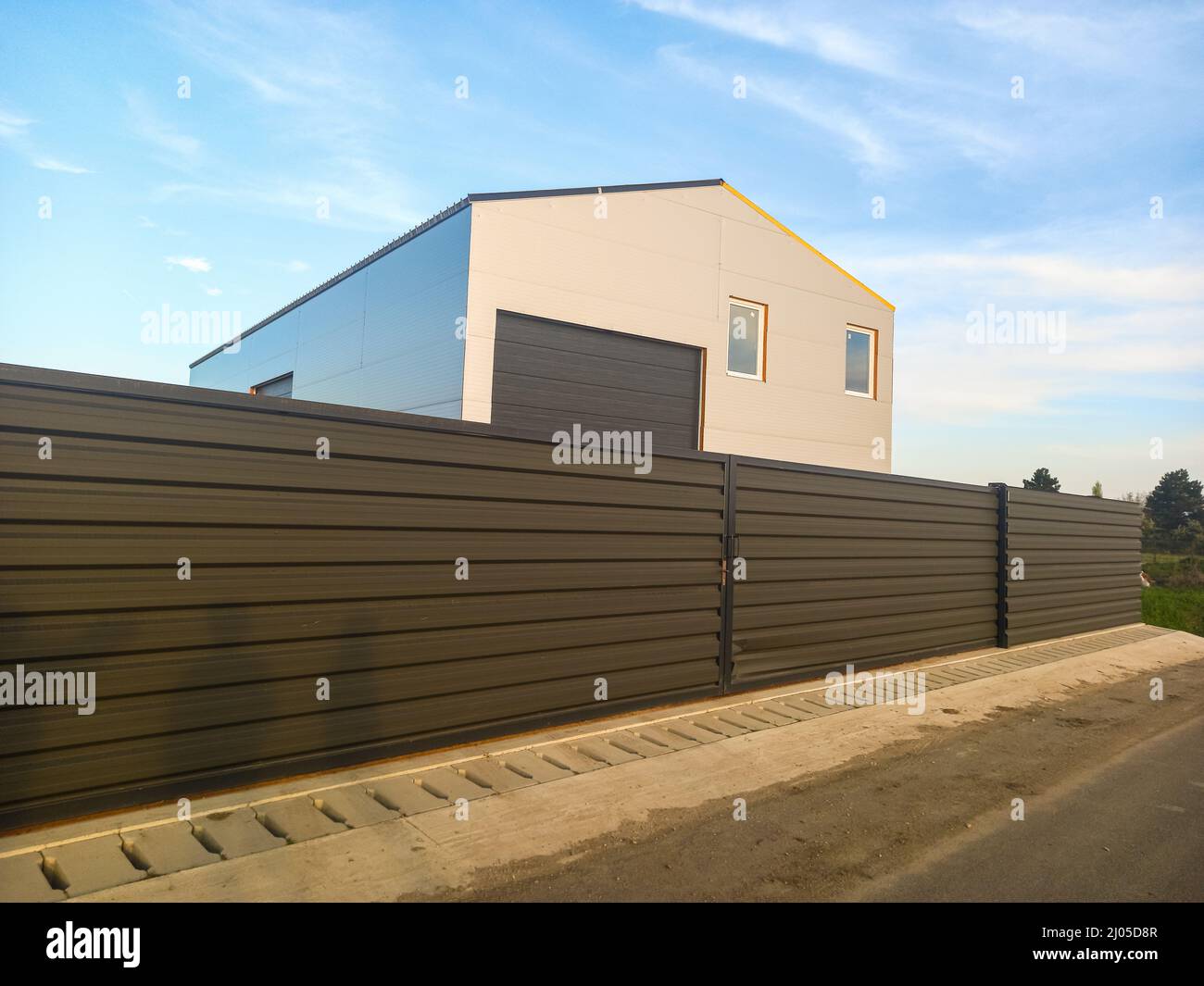 Warehouse building with fence. Industrial warehouse Stock Photo - Alamy