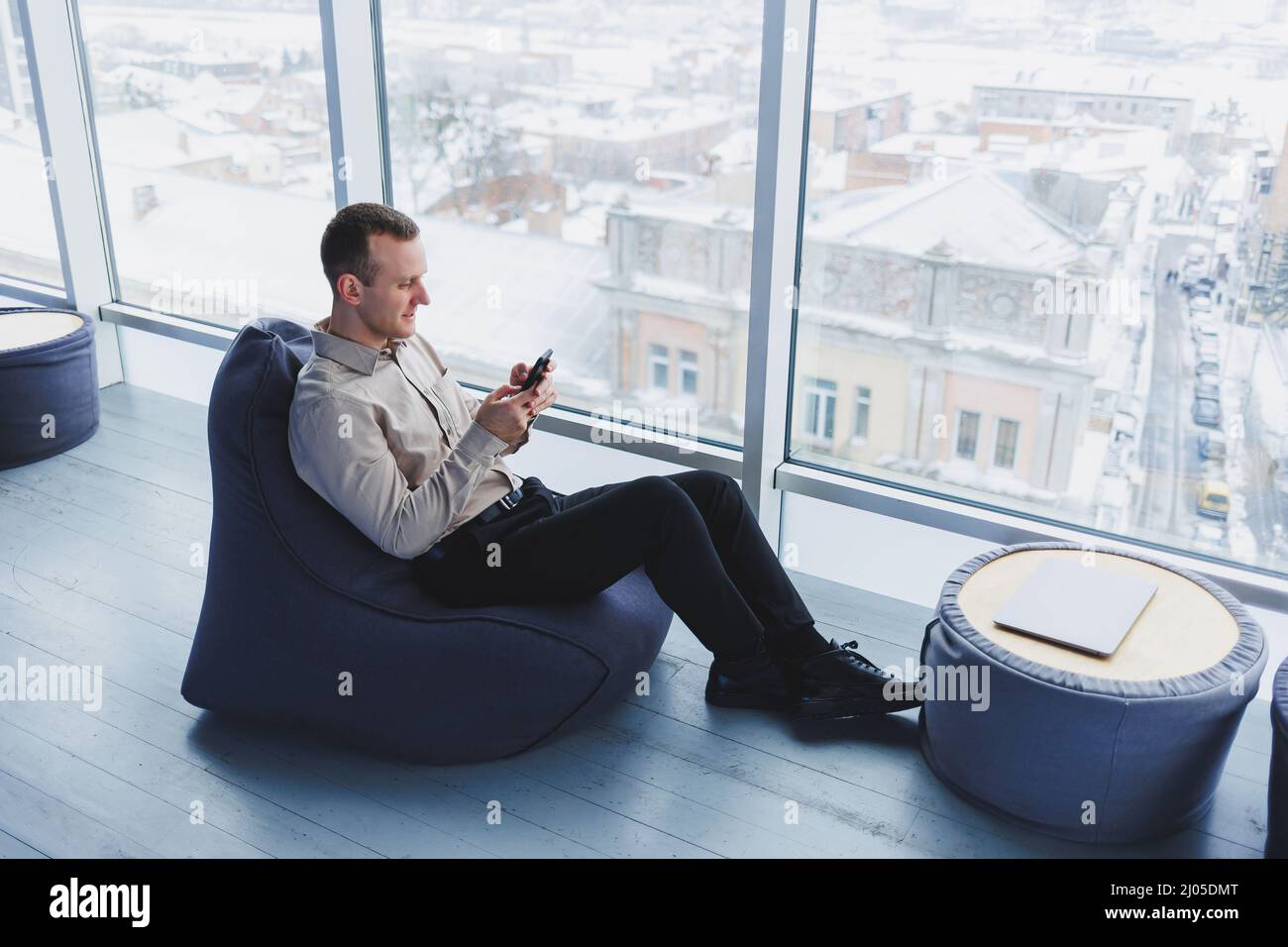 Successful male freelancer sitting in modern workspace and checking ...