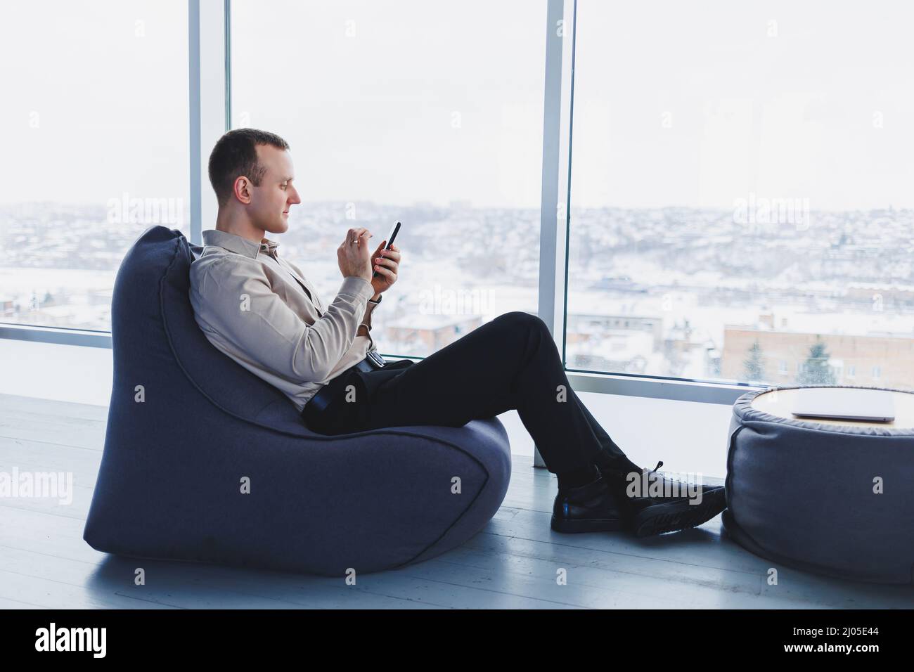 A businessman communicates with his clients by phone while sitting in a ...