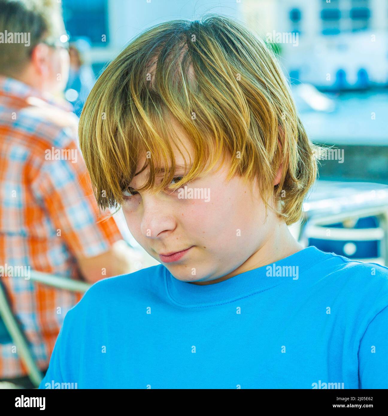 outdoor portrait of relaxed cute young boy looking positive and ...
