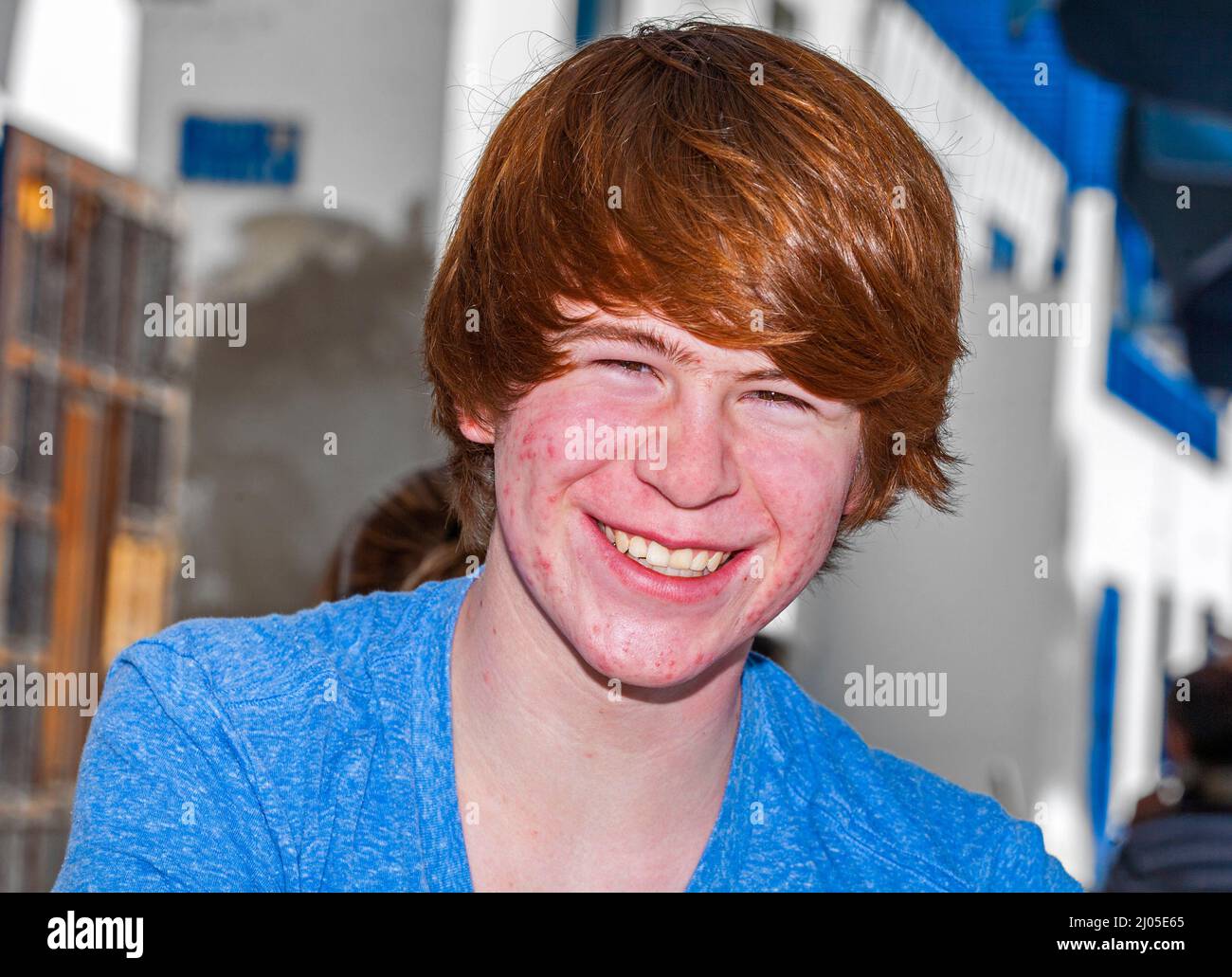 outdoor portrait of relaxed cute young boy looking positive and ...