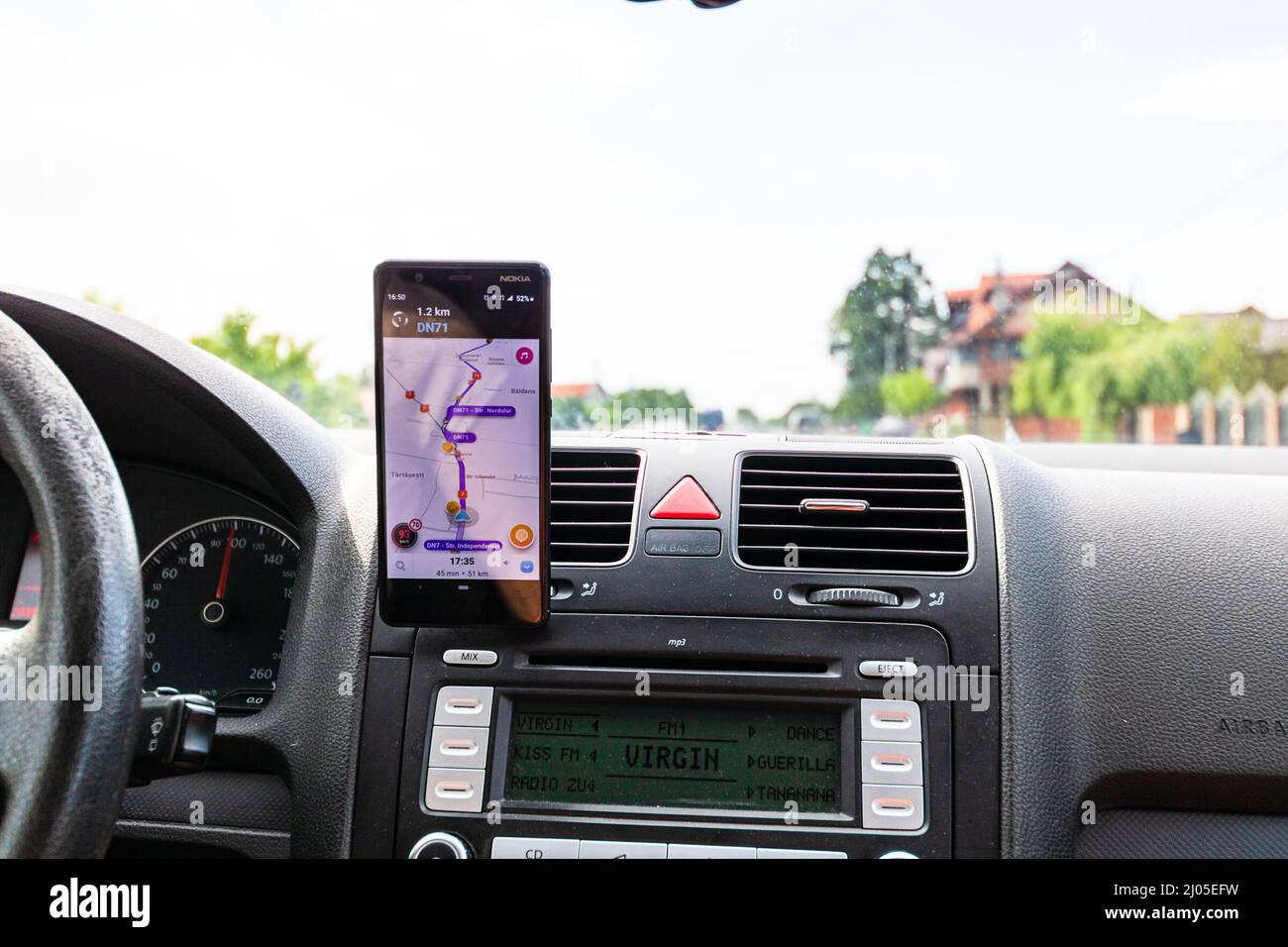 Using waze maps application on smartphone on car dashboard, Driver ...
