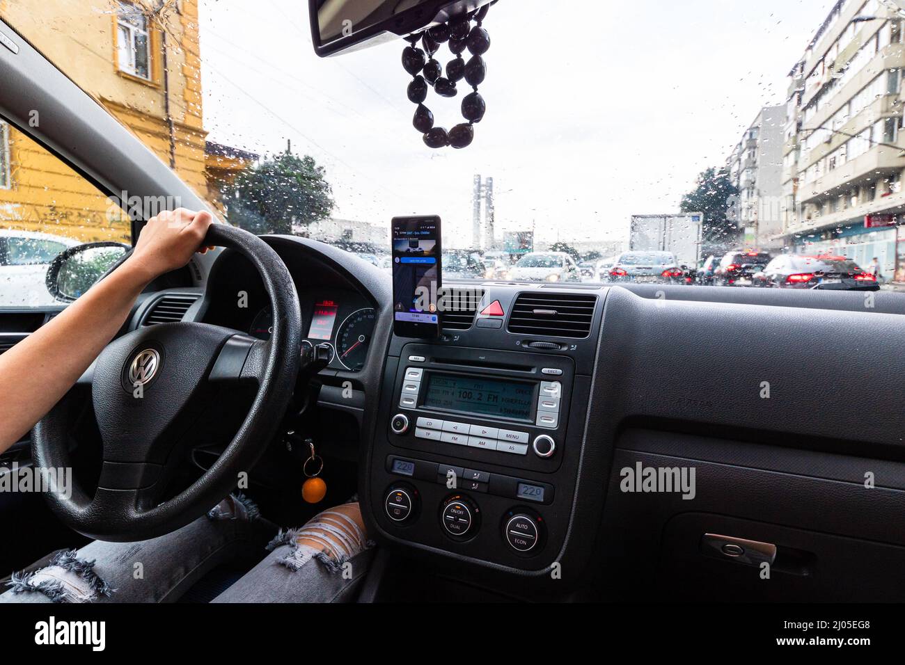 Using waze maps application on smartphone on car dashboard, Driver ...