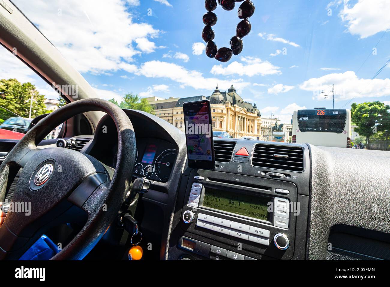 In car dashboard view with smartphone showing Waze maps to show the way ...