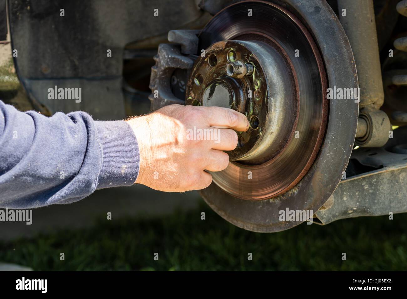 Mechanic cleaning and fixing the brake system of a car in Romania ...