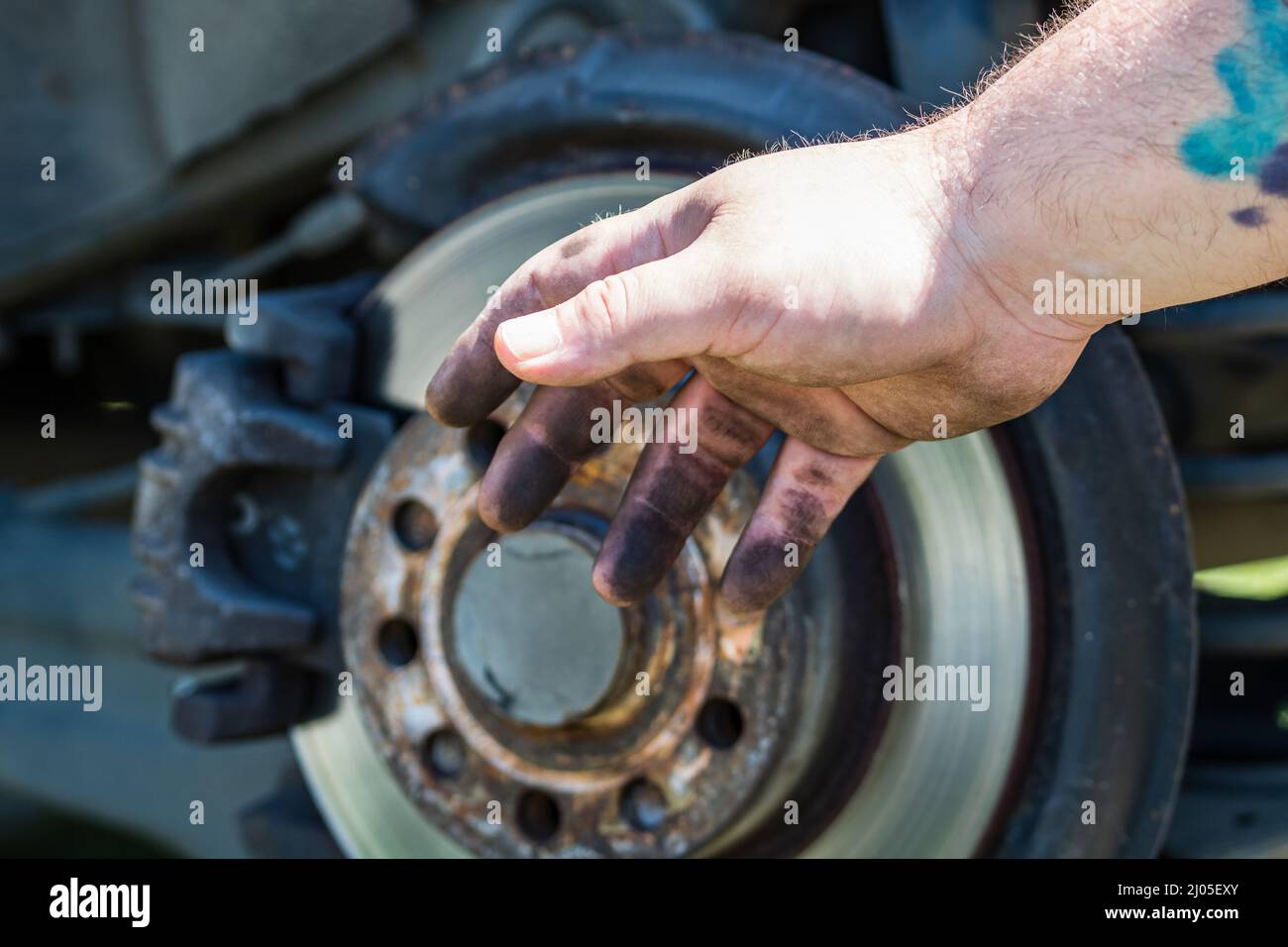 Automotive mechanic checking brake system. Vehicle maintenance in the ...