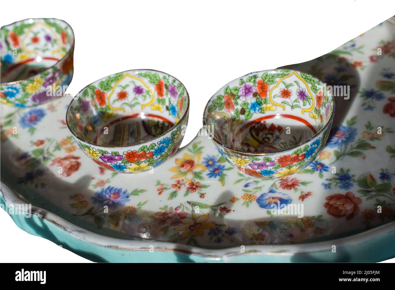 Closeup of a vintage floral tea set isolated on a white background ...