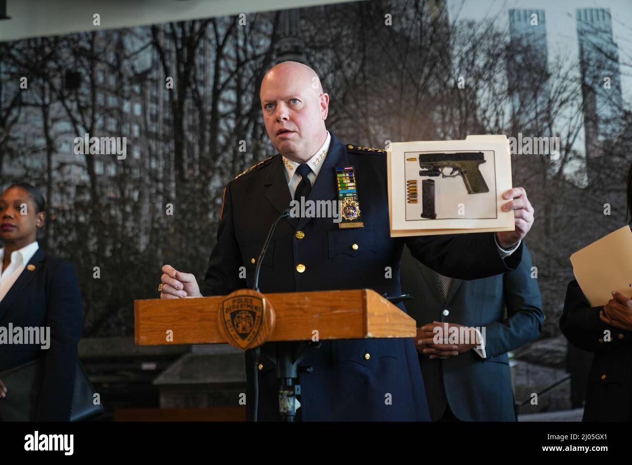 Chief of Department, Kenneth Corey is seen holding a photo of a ...