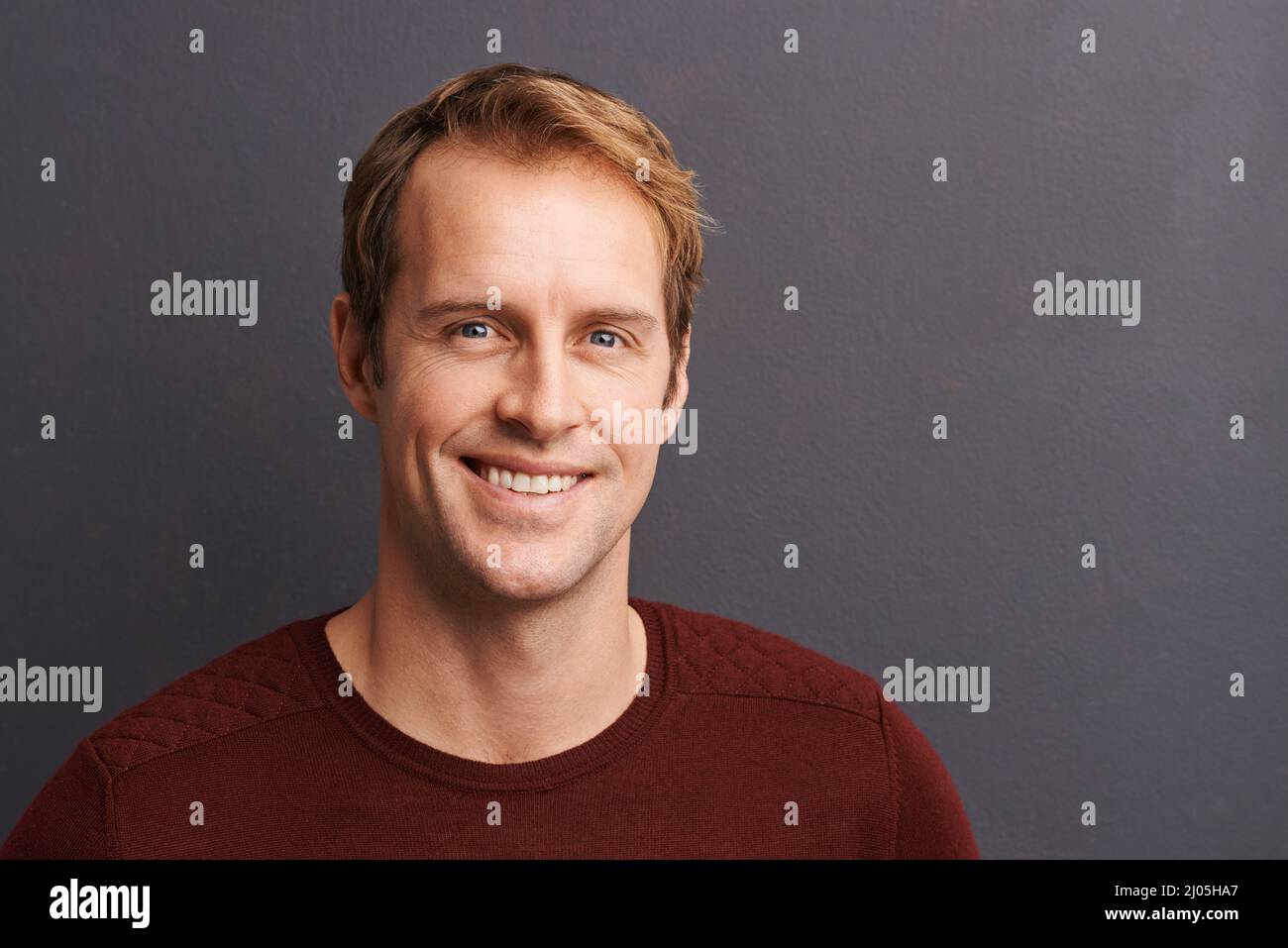 He knows how to turn his charm on. A studio portrait of a handsome man ...