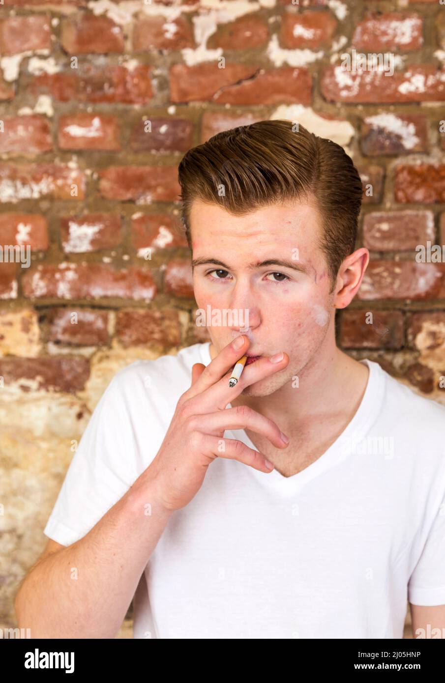 Teen boy smoking cigarette hi-res stock photography and images - Alamy