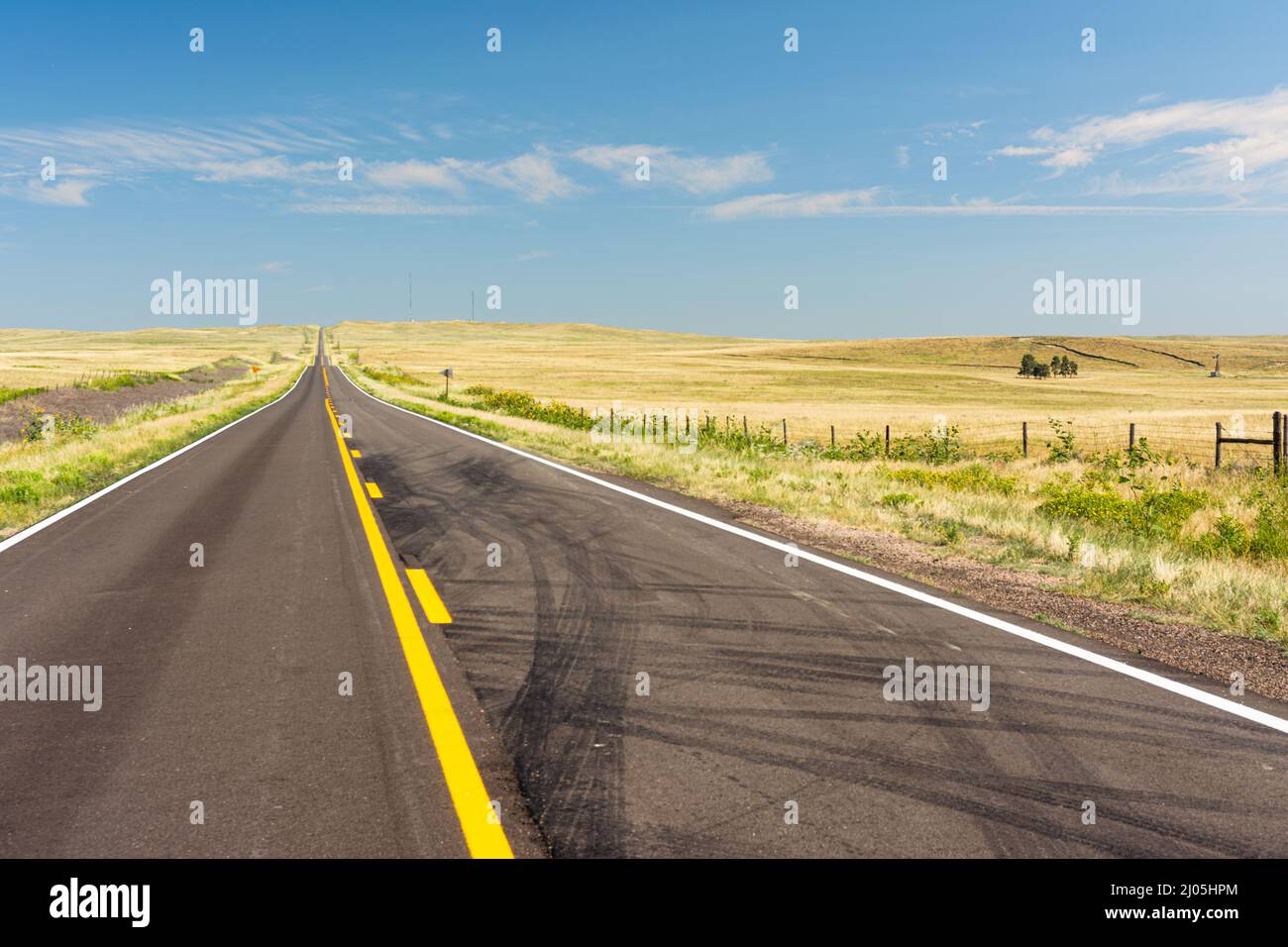 Long empty road surrounded by fields Stock Photo - Alamy