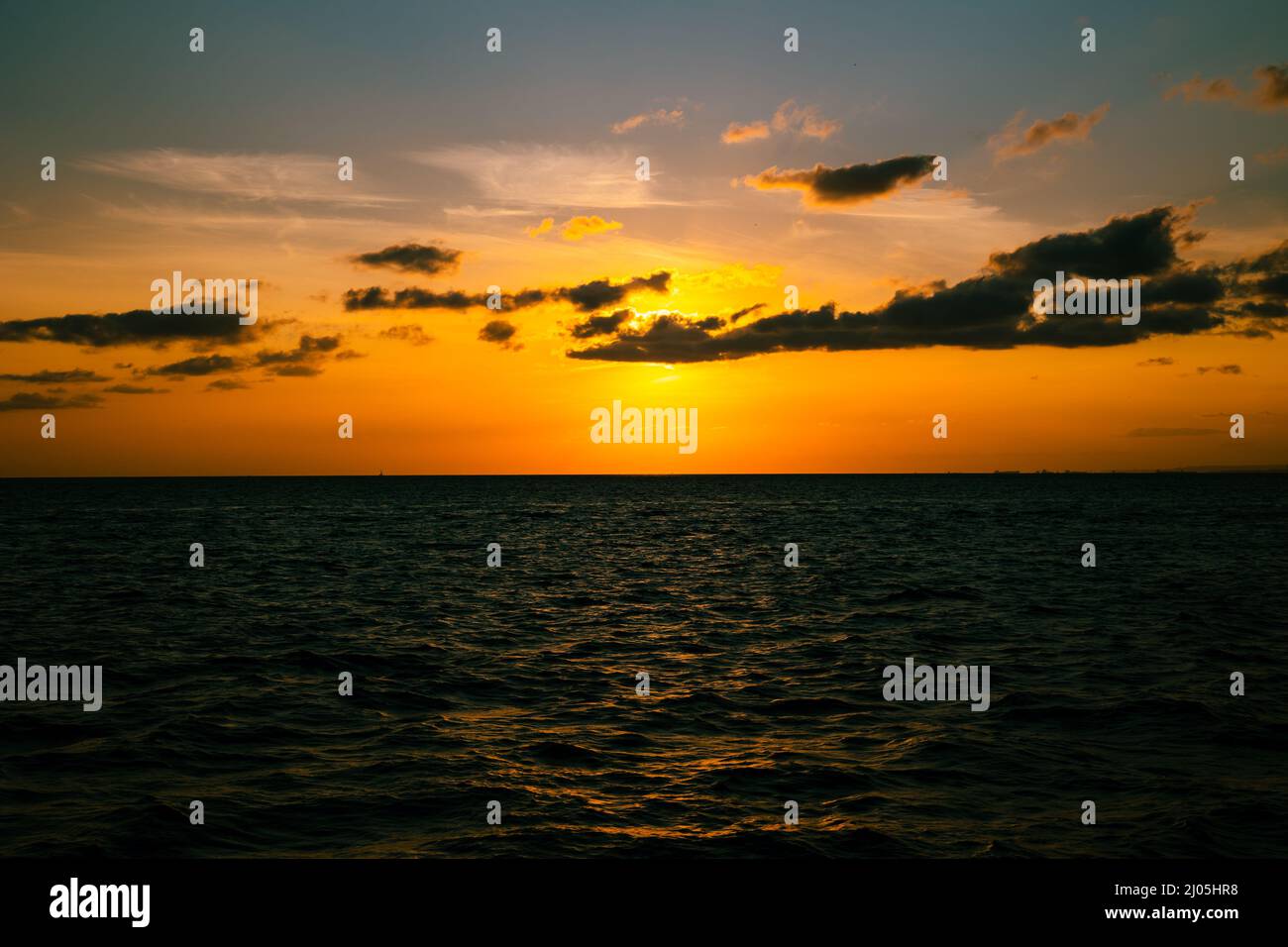 Sunset view from sea. Sunset over the sea and clouds. End of the day ...