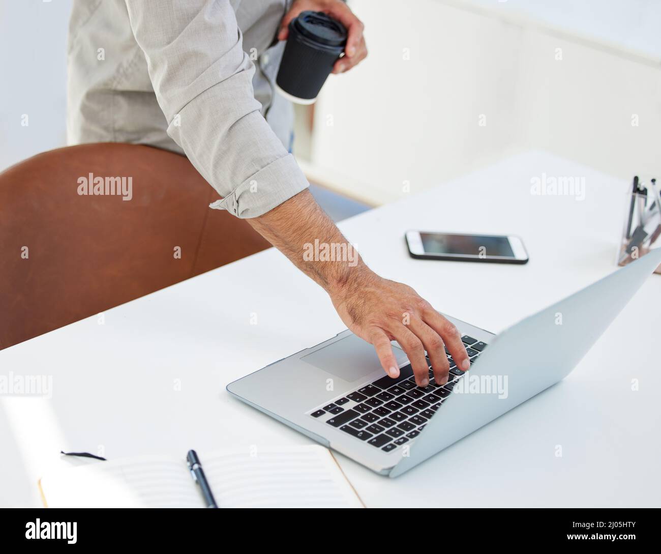 First thing is to check the emails. Shot of a unreconizable man using ...