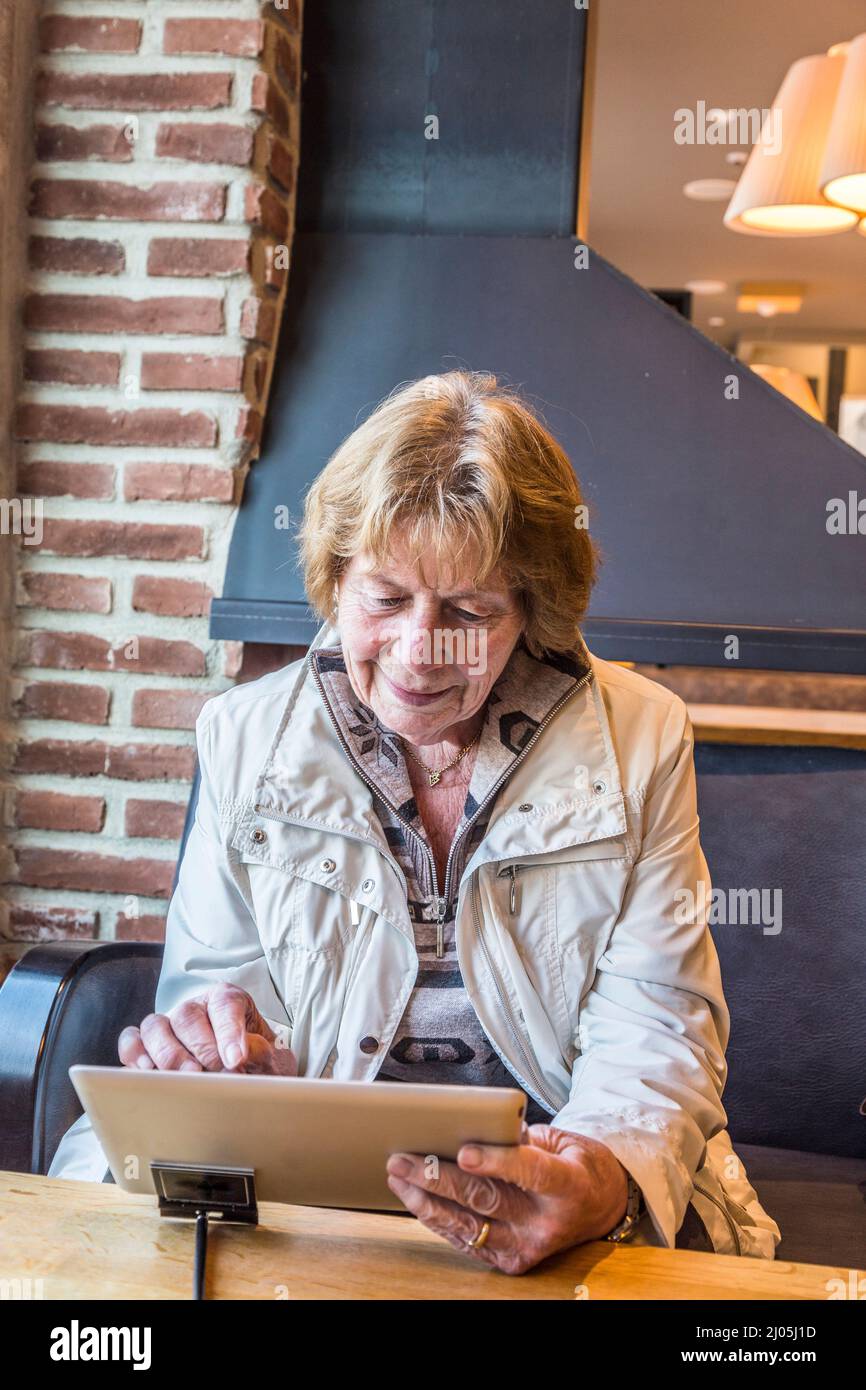 elderly lady has fun using the tablet pc Stock Photo - Alamy
