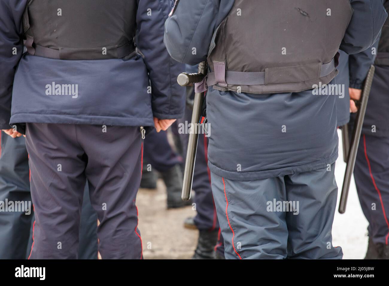 russian police officer with black rubber tonfa baton hanging on his ...