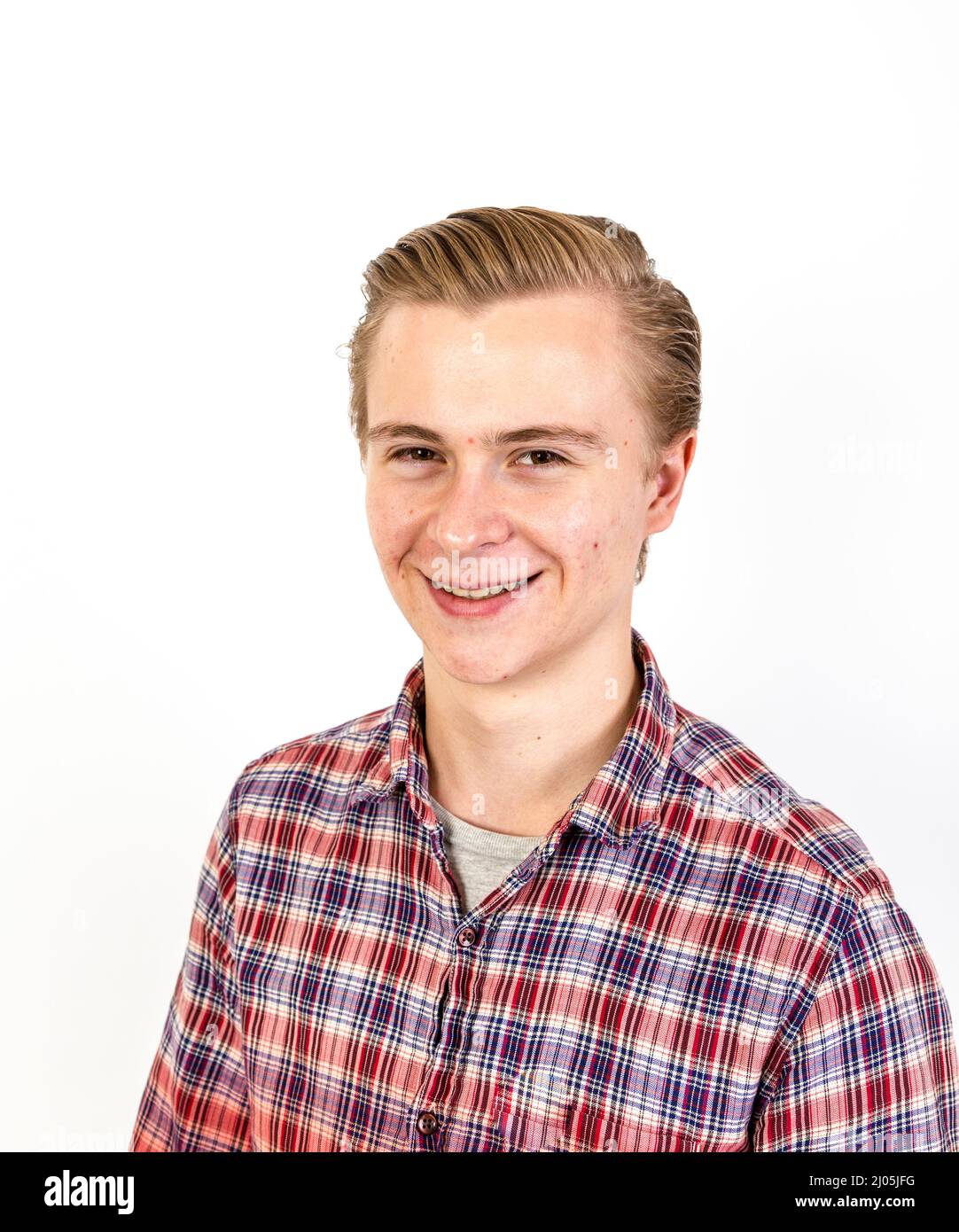 Portrait of a positive boy looking at camera. Isolated over white Stock ...