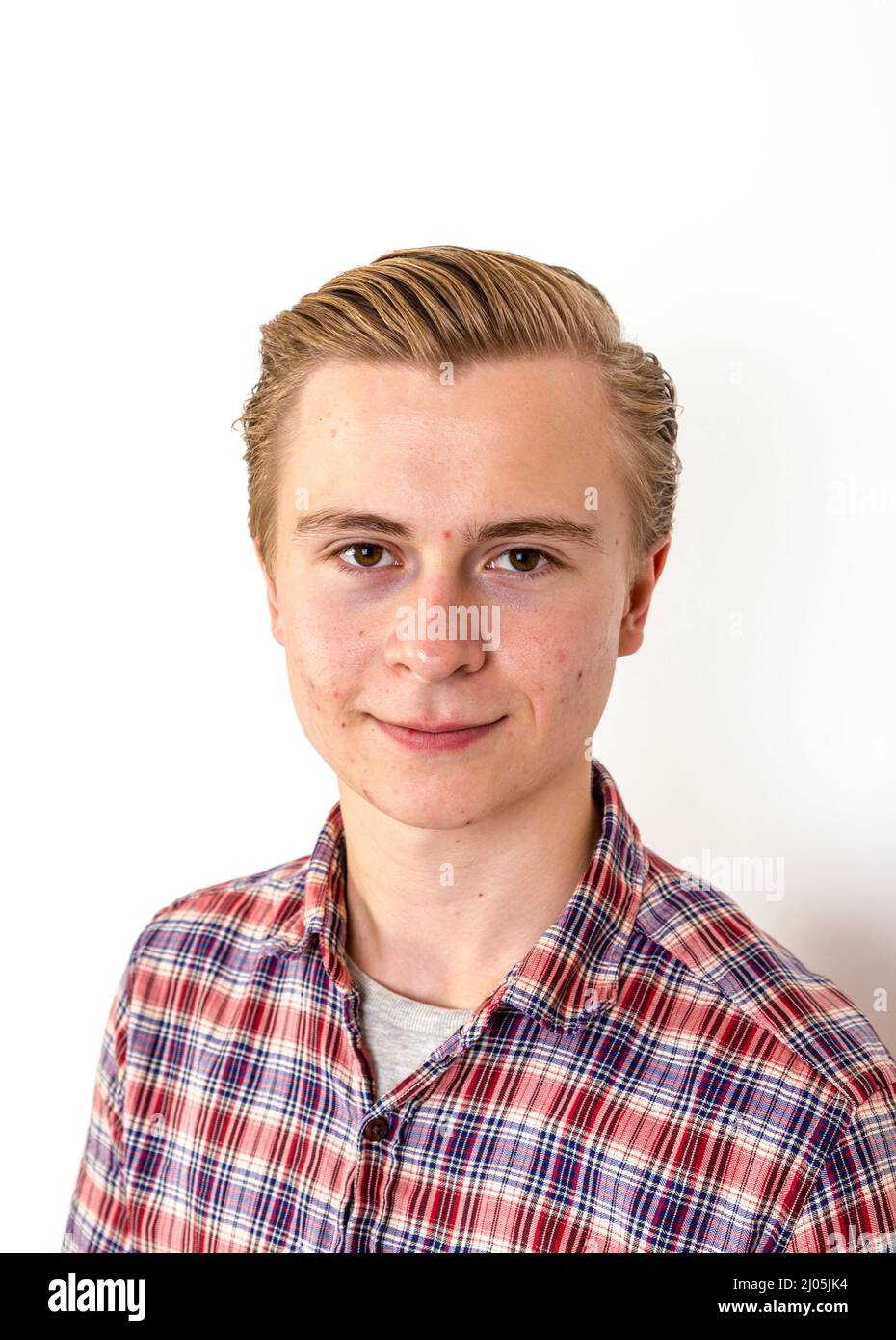 Portrait of a positive boy looking at camera. Isolated over white Stock ...