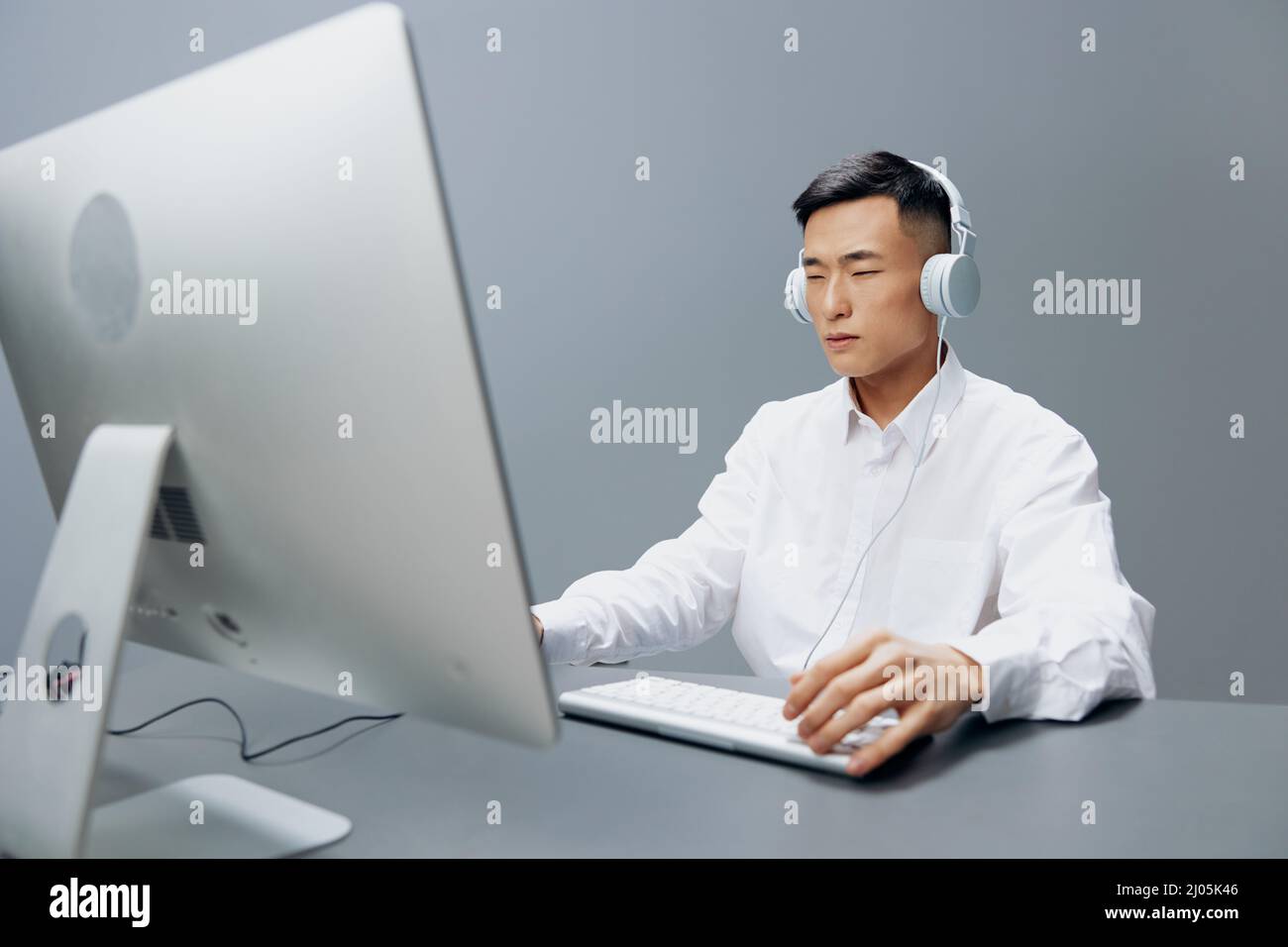 Asian man computer with keyboard on desk in office internet Gray ...