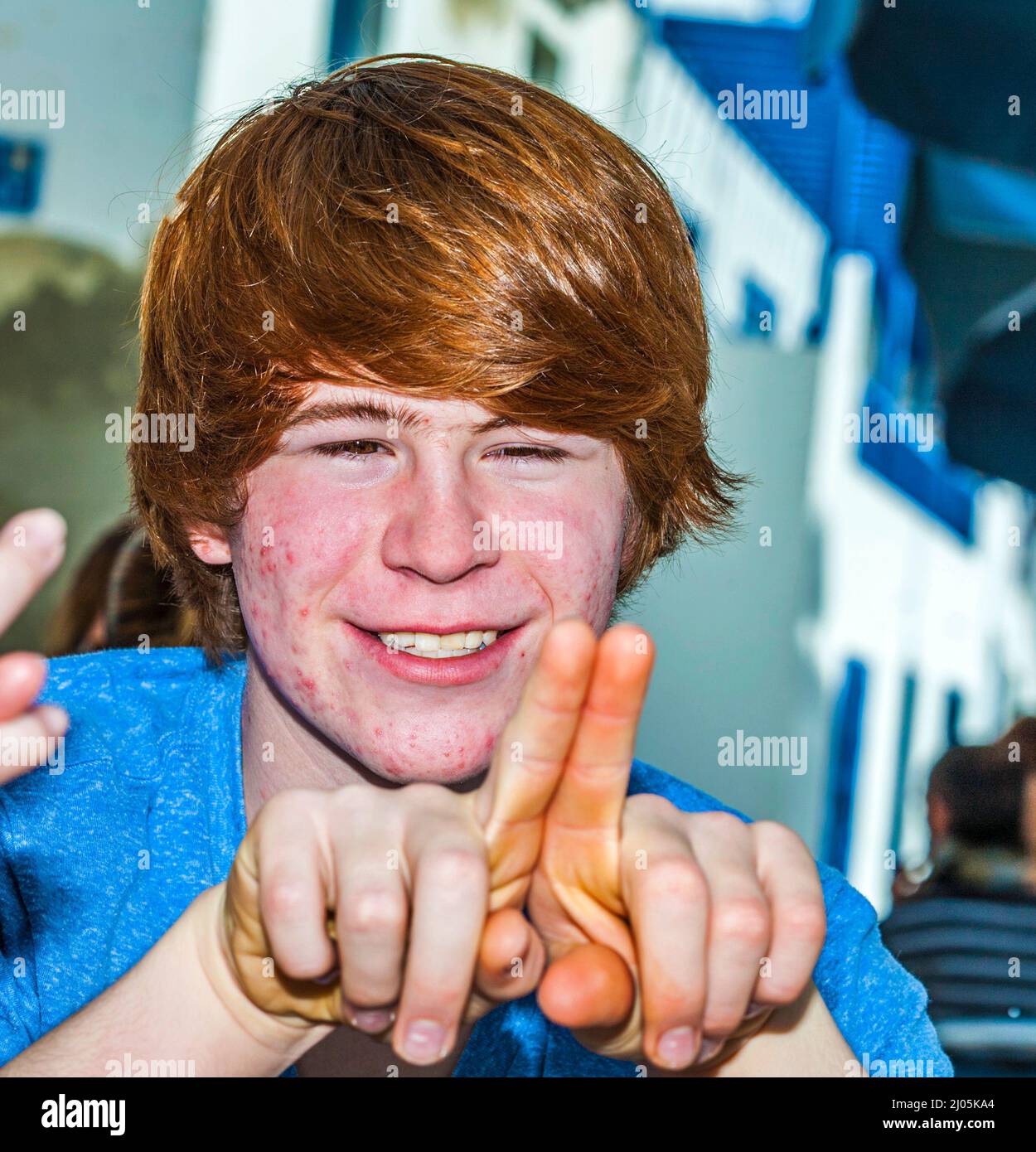 outdoor portrait of relaxed cute young boy looking positive and ...