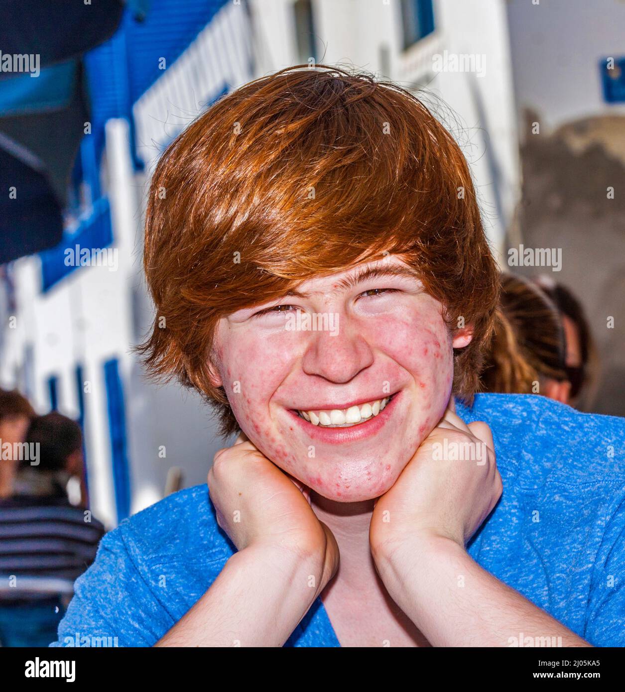 outdoor portrait of relaxed cute young boy looking positive and ...