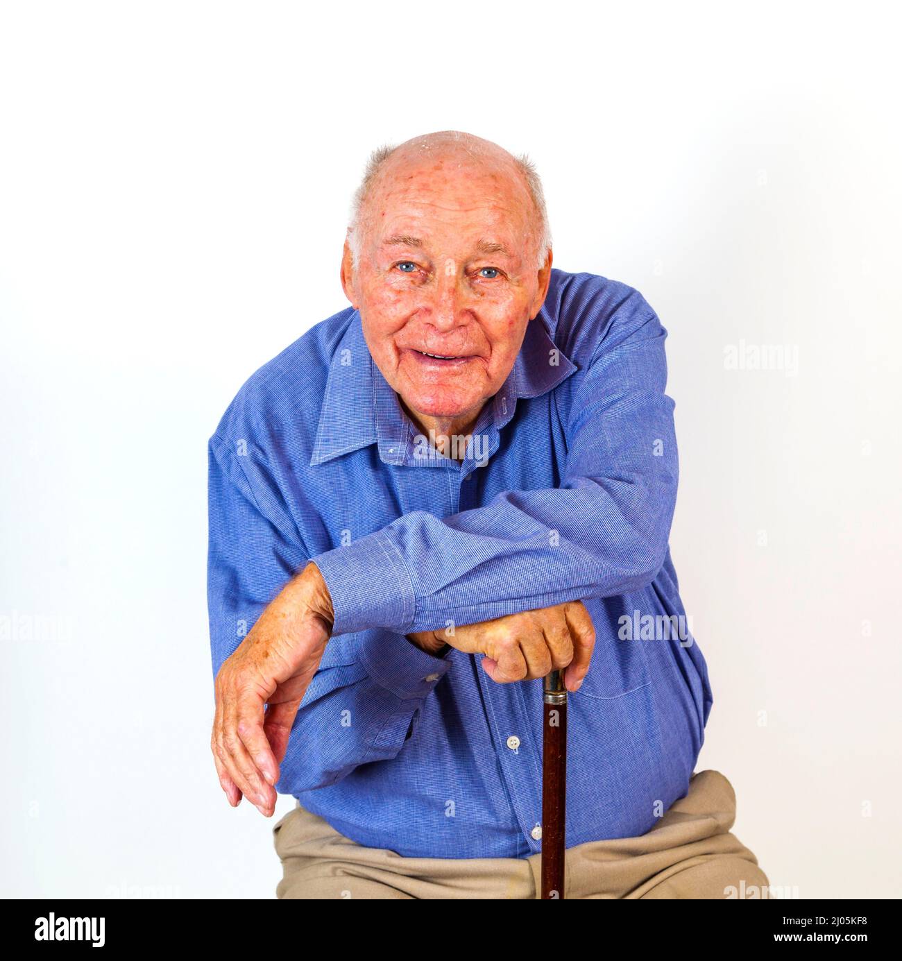happy elderly man sitting in front of a white background Stock Photo ...