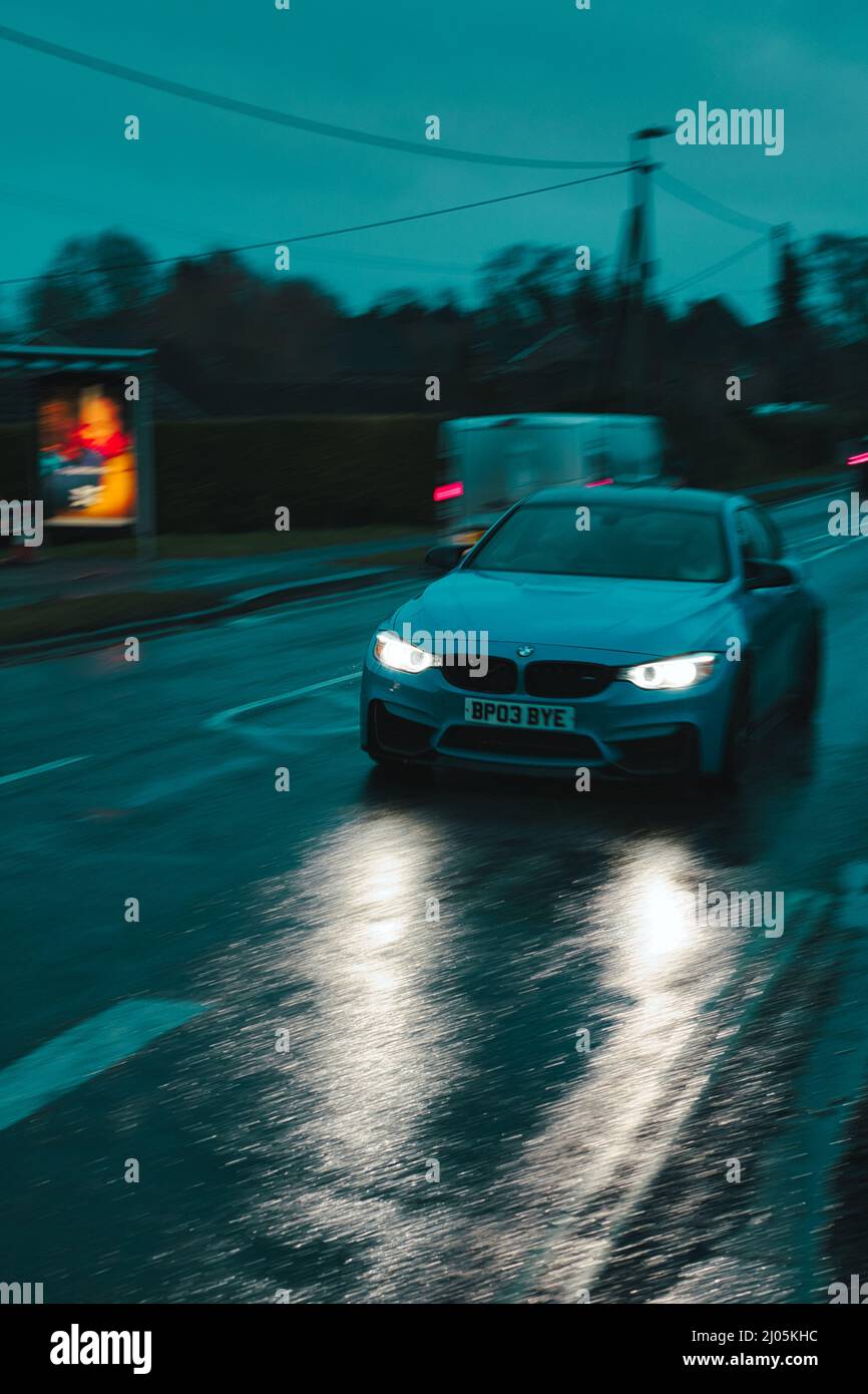 Aqua blue BMW M4 in the rainy weather Stock Photo - Alamy