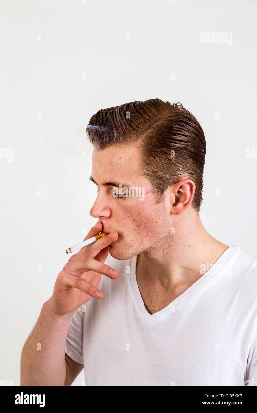 teenage boy with red hair smoks a cigarette Stock Photo - Alamy