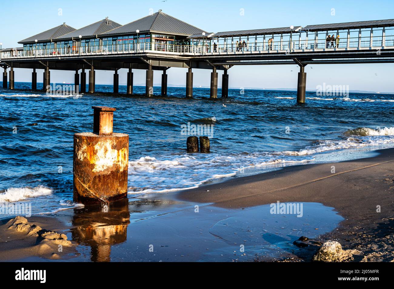 A rusty pole on the baltic sea beach in front of the pier Stock Photo ...
