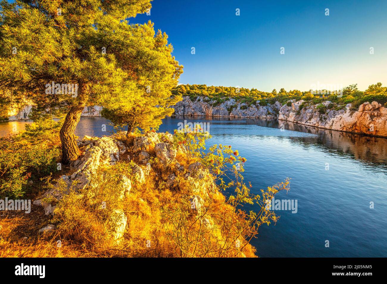 The Zmajevo oko, Dragon's Eye lake at sunset. The Rogoznica village, a ...